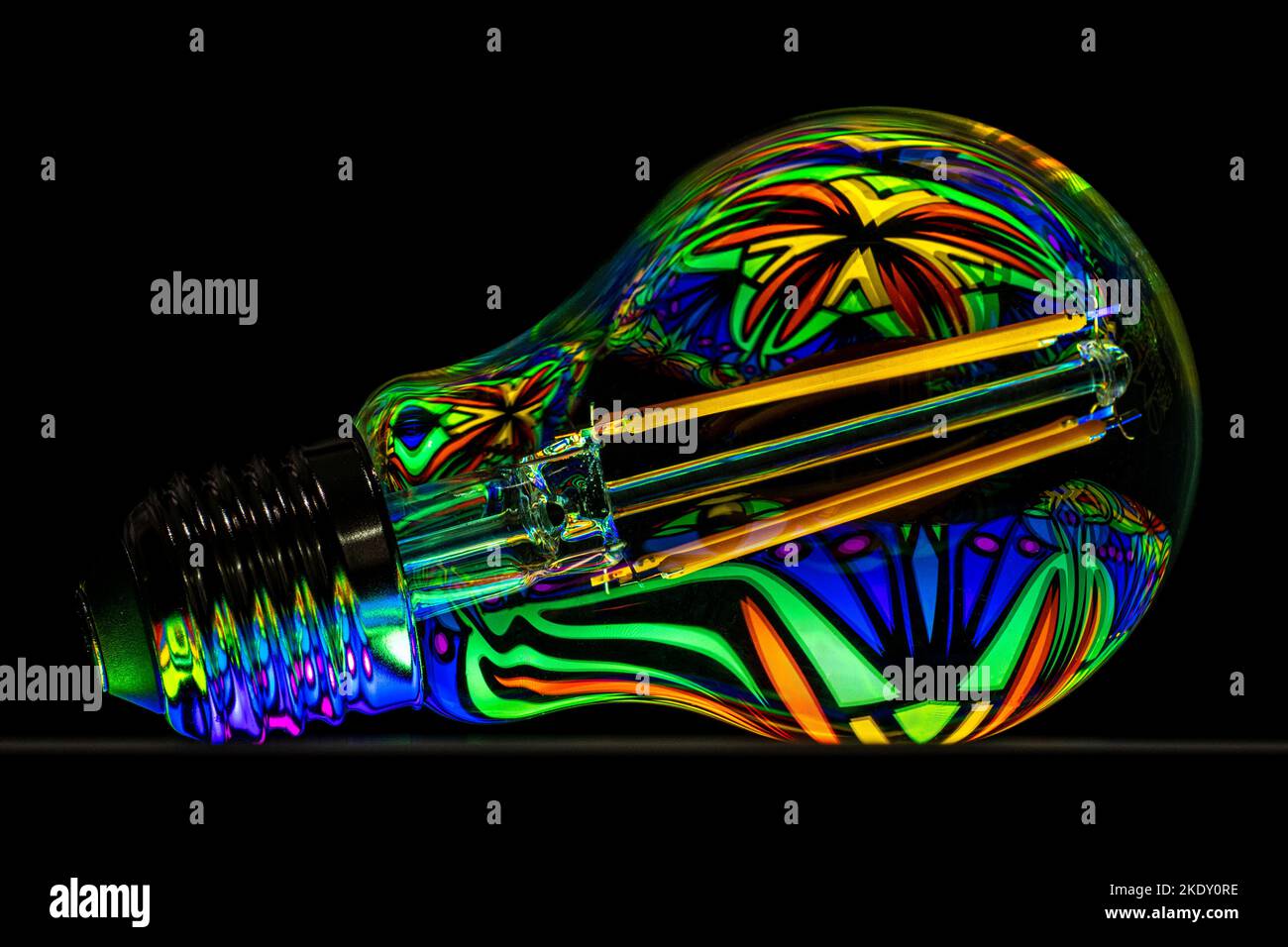 A Light Bulb on a black background with a bright pattern reflection ...