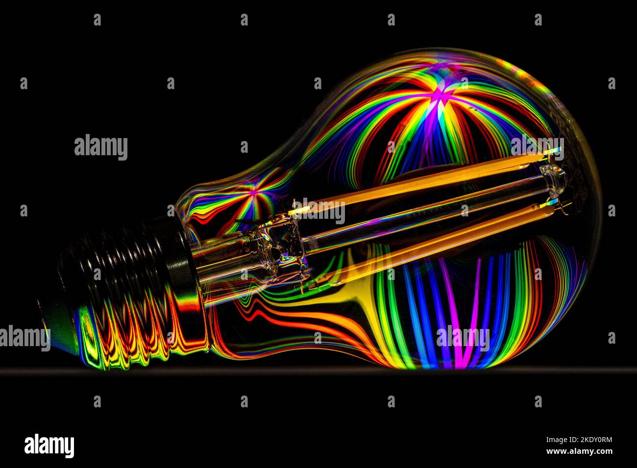 A Light Bulb on a black background with a bright pattern reflection ...