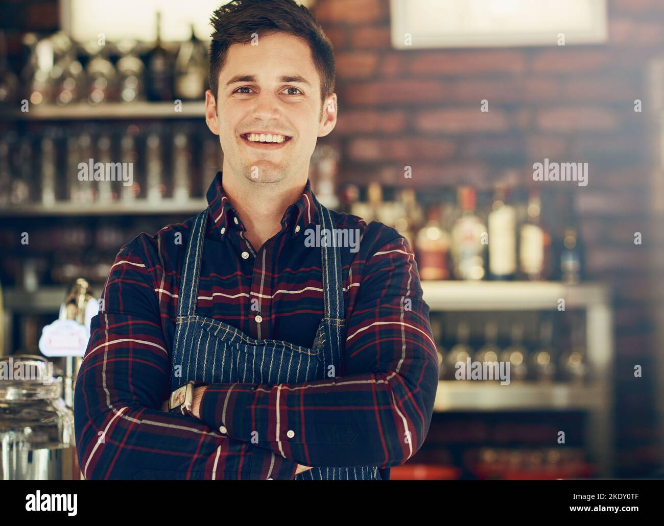 Hes the proud owner of a new restaurant. Portrait of a smiling young ...