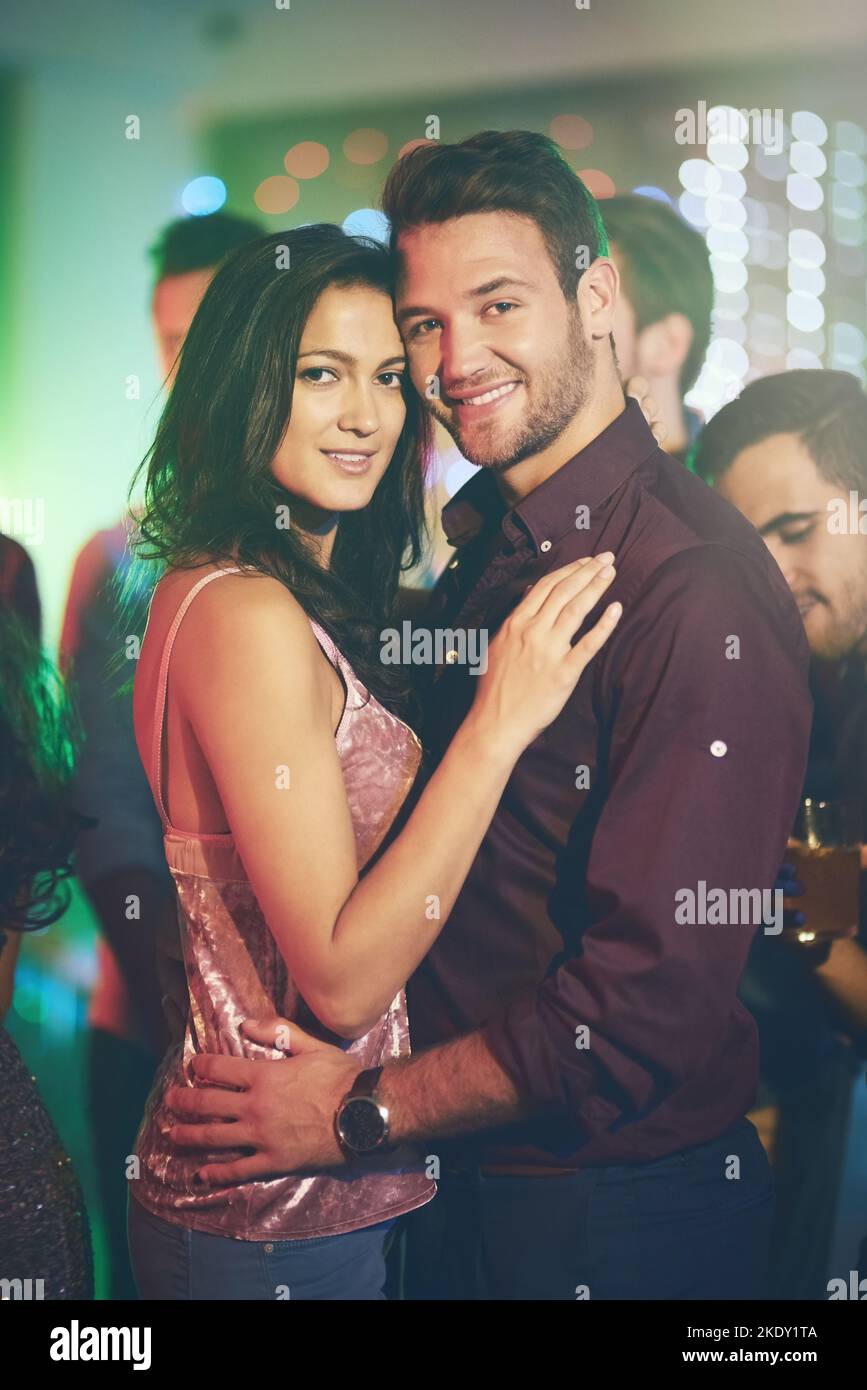 We love the nightlife. an affectionate young couple dancing on a ...