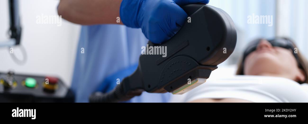 Cosmetologist removing unwanted hair from client body using laser ...