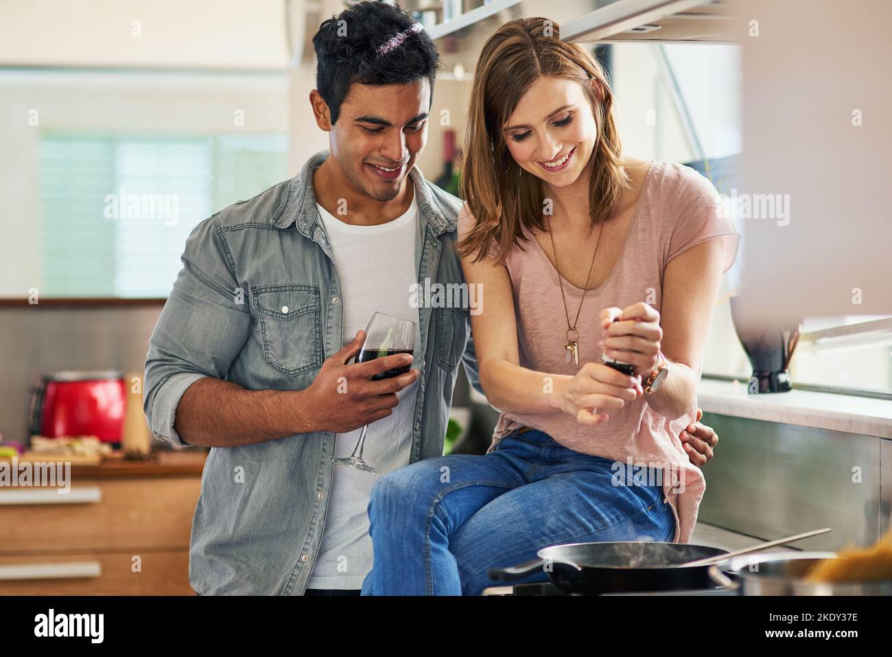 Just a little seasoning...an attractive young couple drinking wine and ...