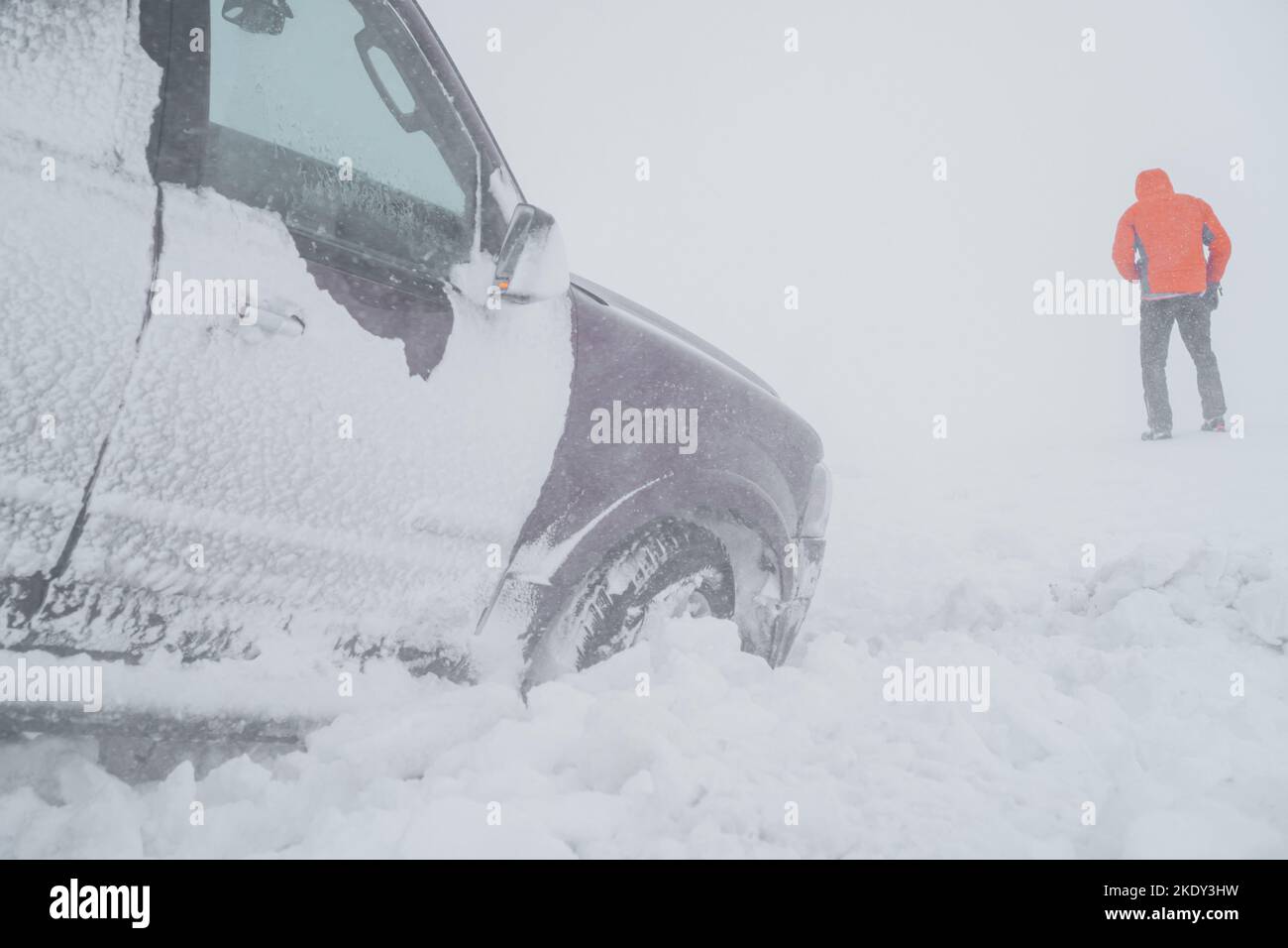 man walking in the snow, when his car breaks down Stock Photo - Alamy