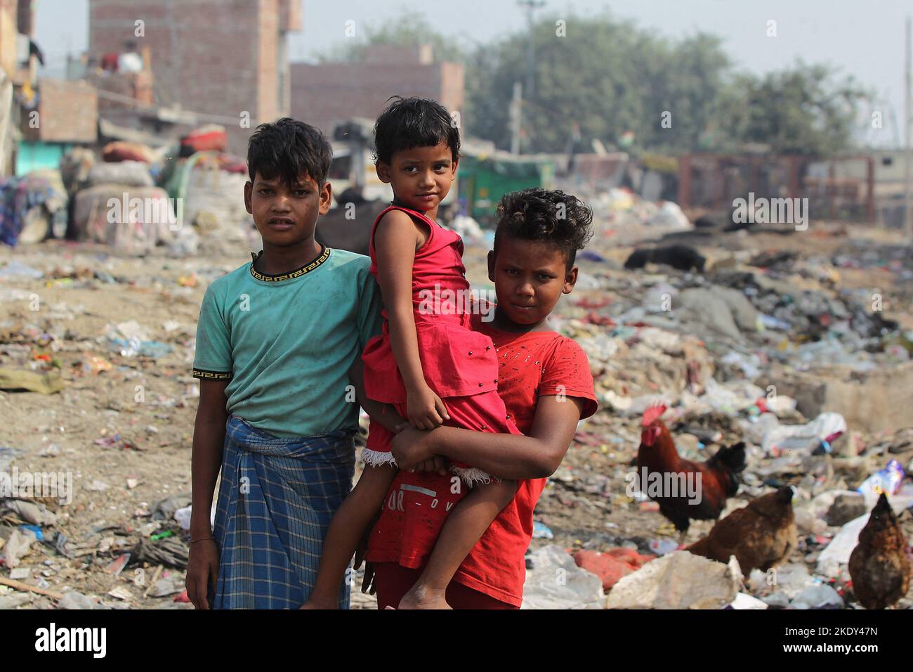A kid gathers garbage at a poor sanitation conditions site near ...