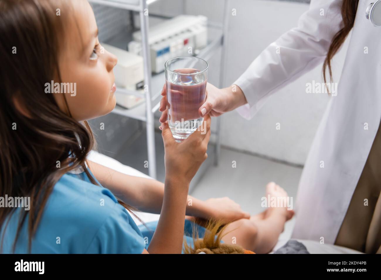 Doctor giving glass of water to child on hospital bed,stock image Stock ...