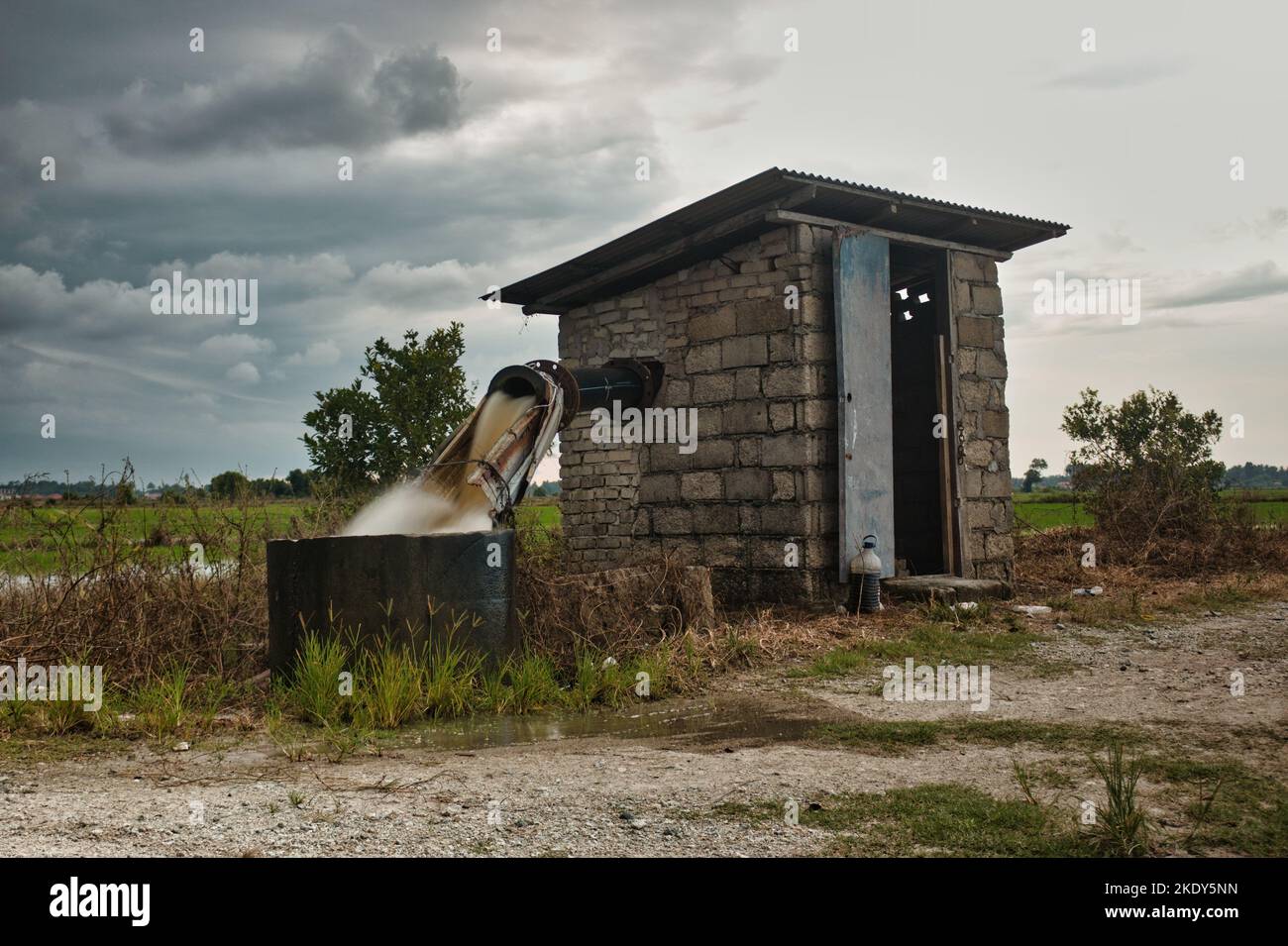 A rural water pump watering the rice fields Stock Photo - Alamy