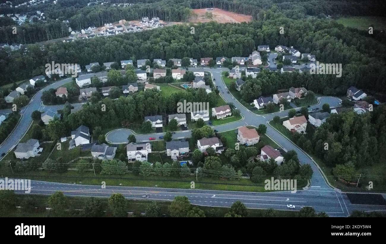 An aerial view of residential similar houses on green land in a ...
