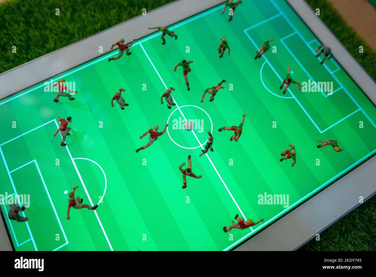 Top view of miniature toys figurines football (soccer) players on a ...