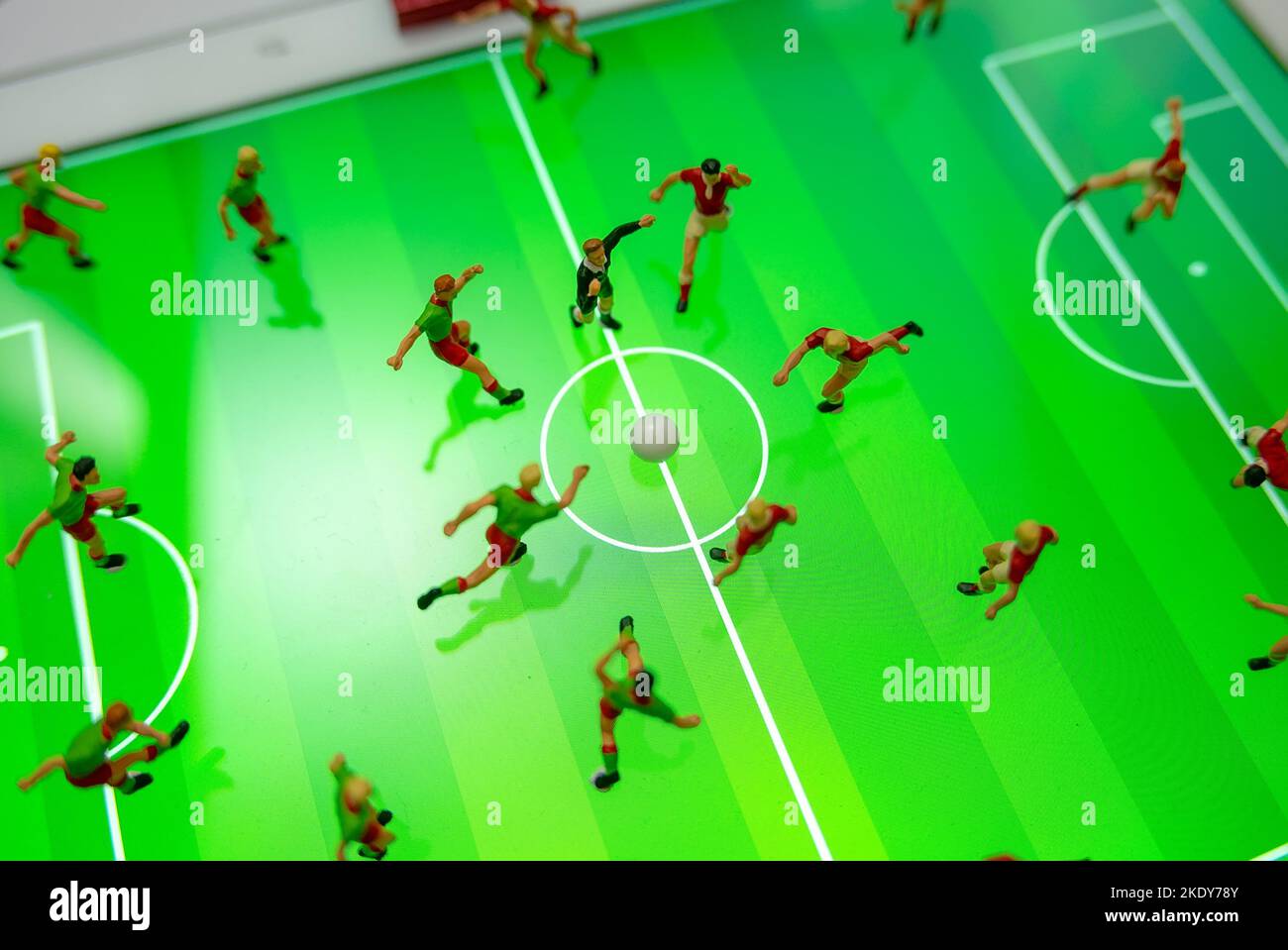 Top view of miniature toys figurines football (soccer) players on a ...