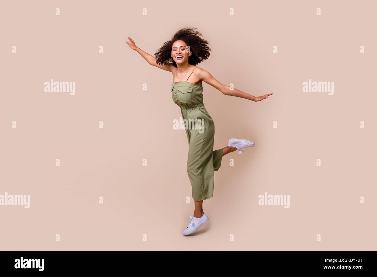 Full body photo of pretty young woman wavy hair jump spread hands plane ...