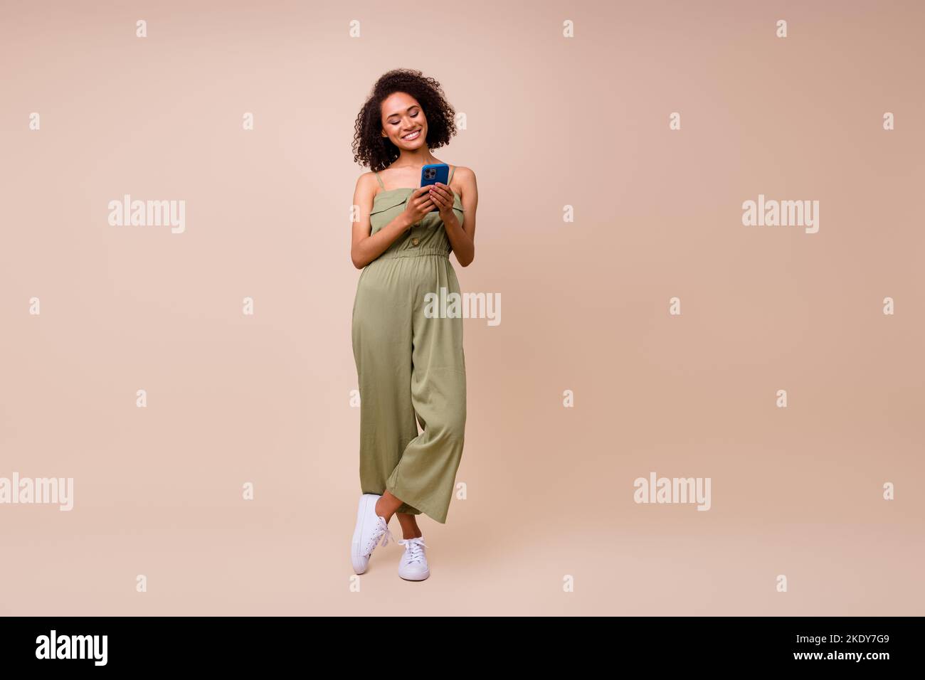 Full size photo of good mood girl with wavy hairstyle dressed khaki ...
