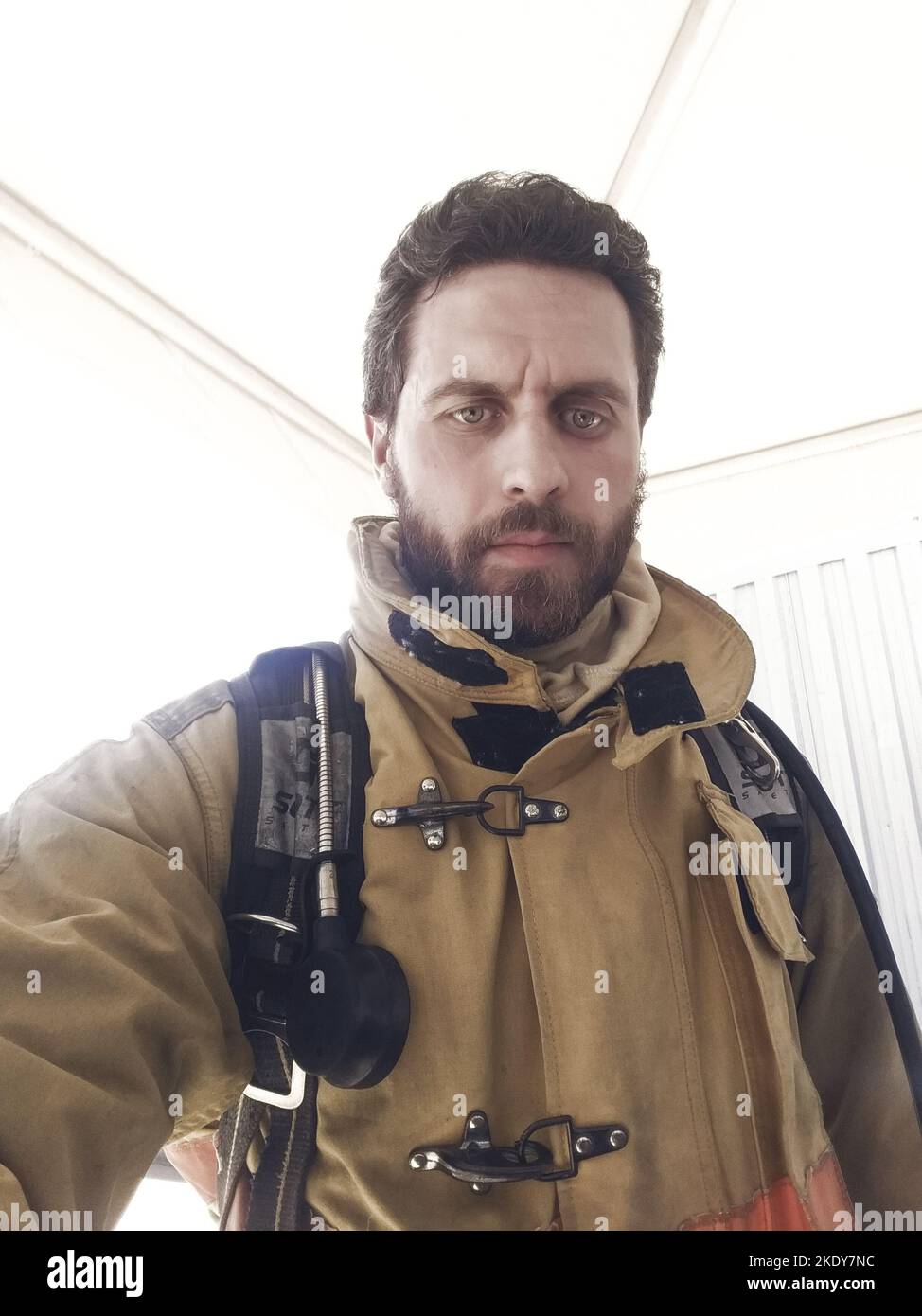 On guard. Firefighter with uniform taking selfie. Masculinity and male ...