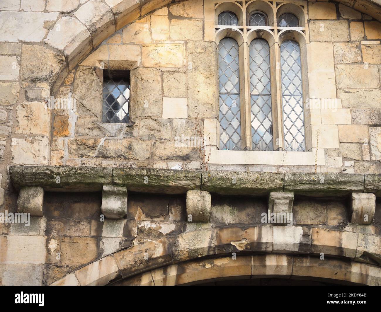 Details of the stonework and leaded windows of an mediaeval building ...