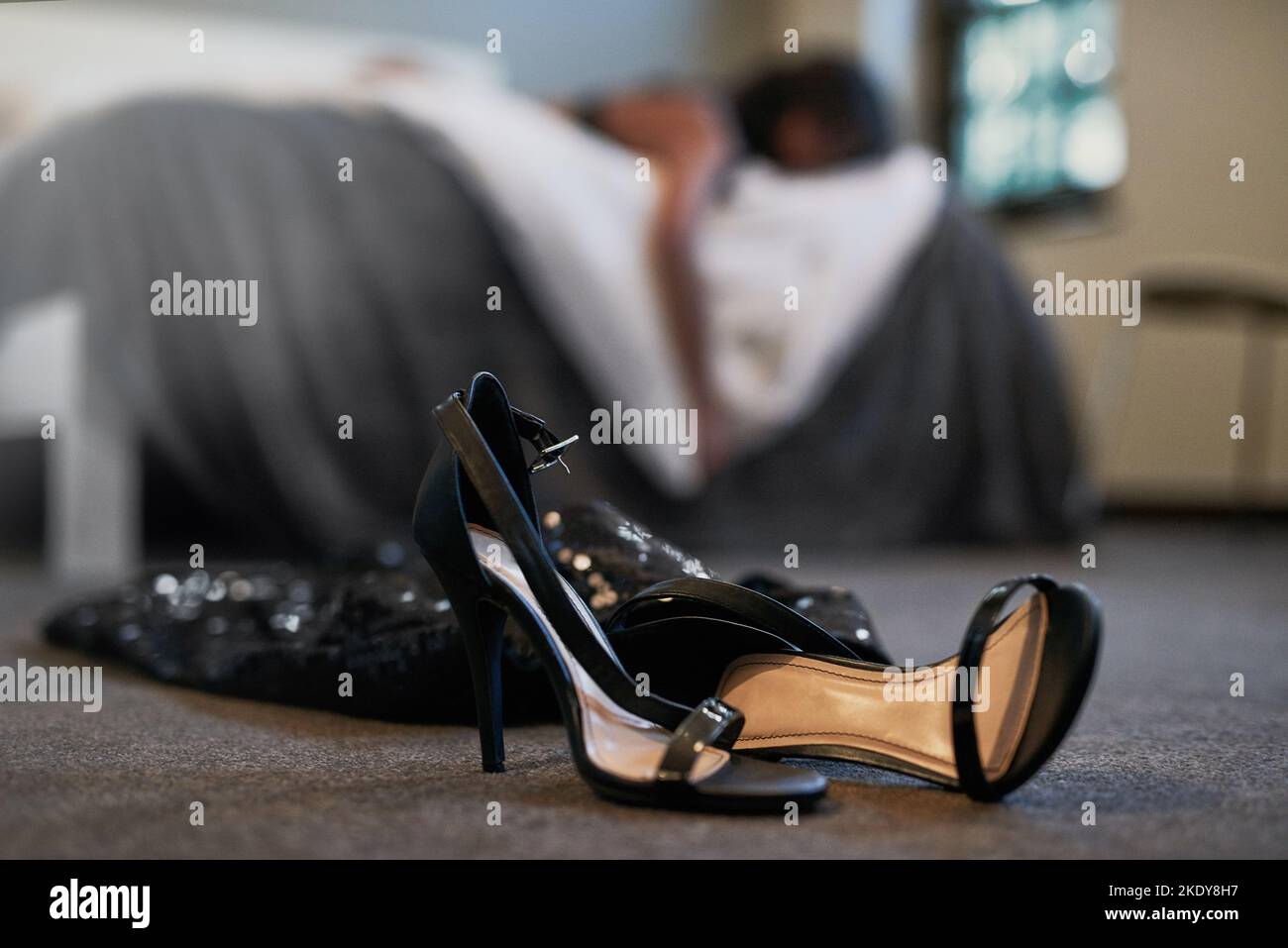 The morning after the night before. a woman sleeping in her bed while ...