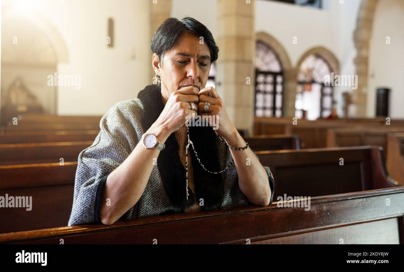 Faith, senior woman and in church with rosary for prayer, worship God ...