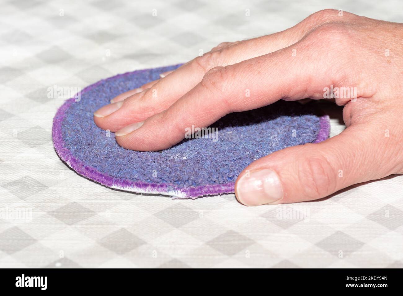 General house cleaning. Wiping the surface from dust with a purple rag ...