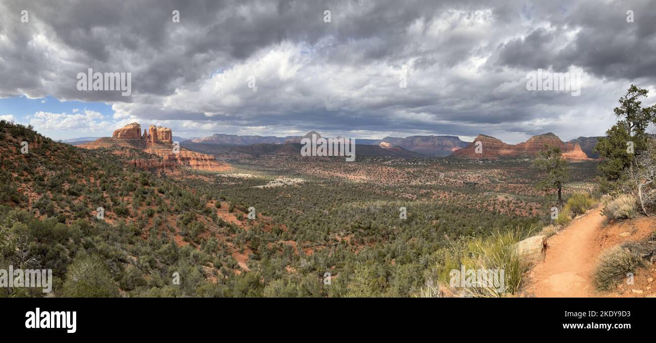 A panoramic view of large fields and Cathedral Rock under a gray cloudy ...