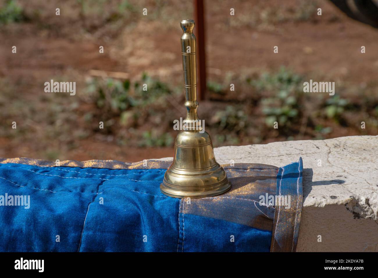 A carved copper or bronze hand bell used in Hindu temples put under ...