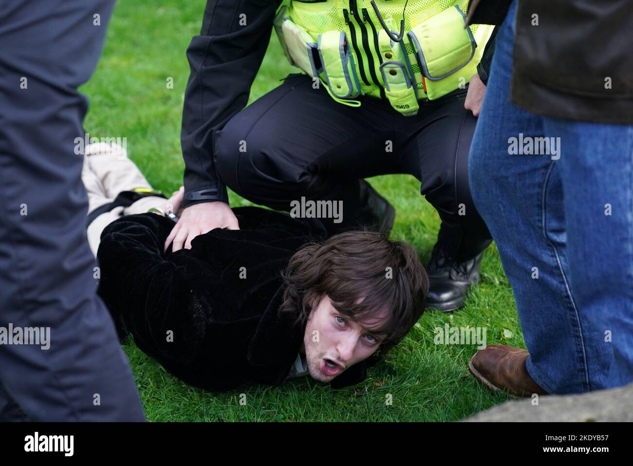 Police detain protester Patrick Thelwell after he appeared to throw ...