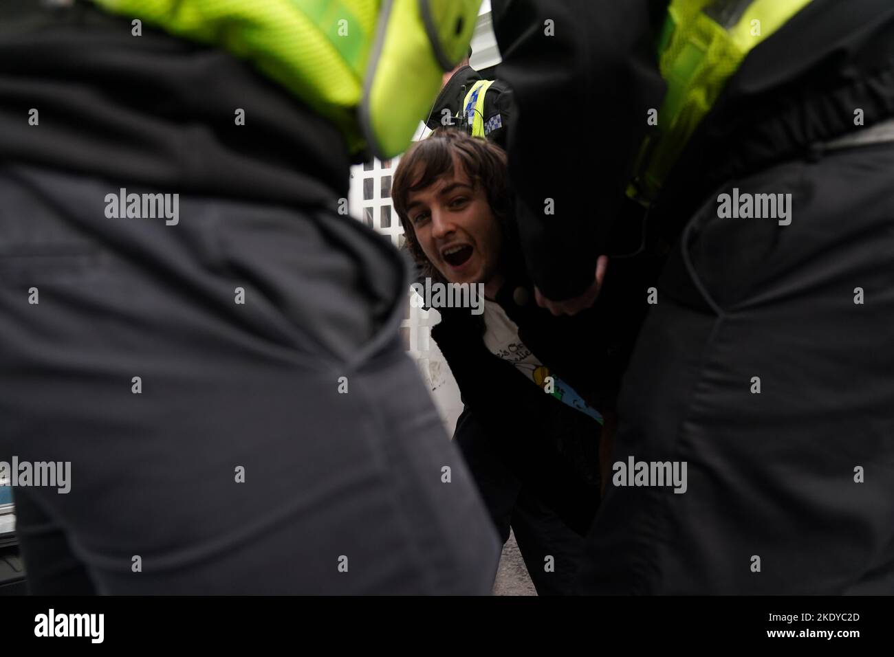 Police detain protester Patrick Thelwell after he appeared to throw ...