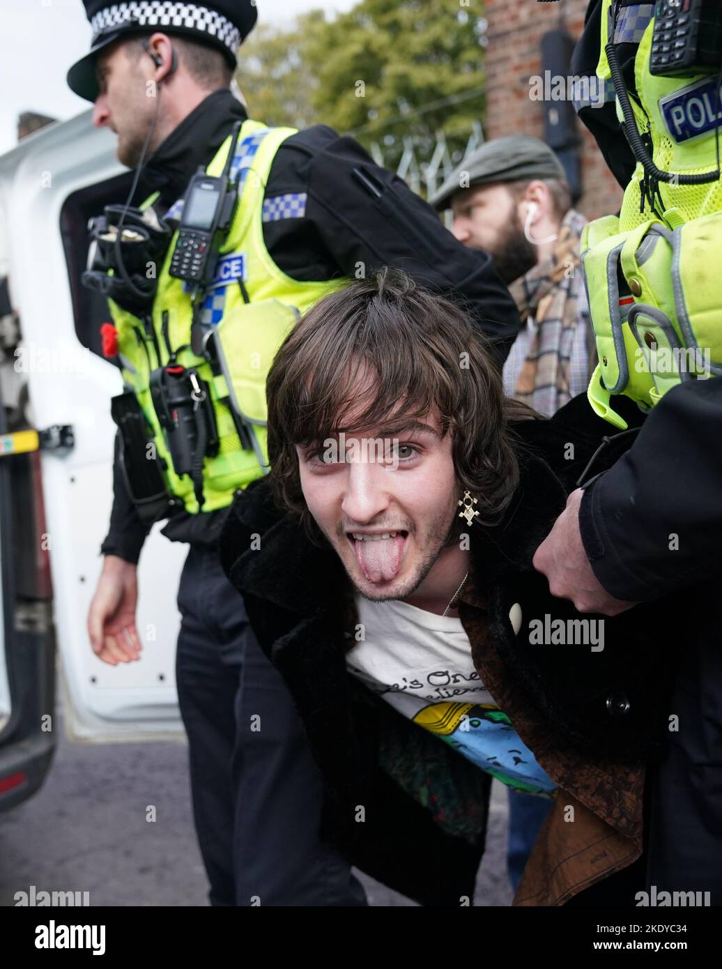 Police detain protester Patrick Thelwell after he appeared to throw ...