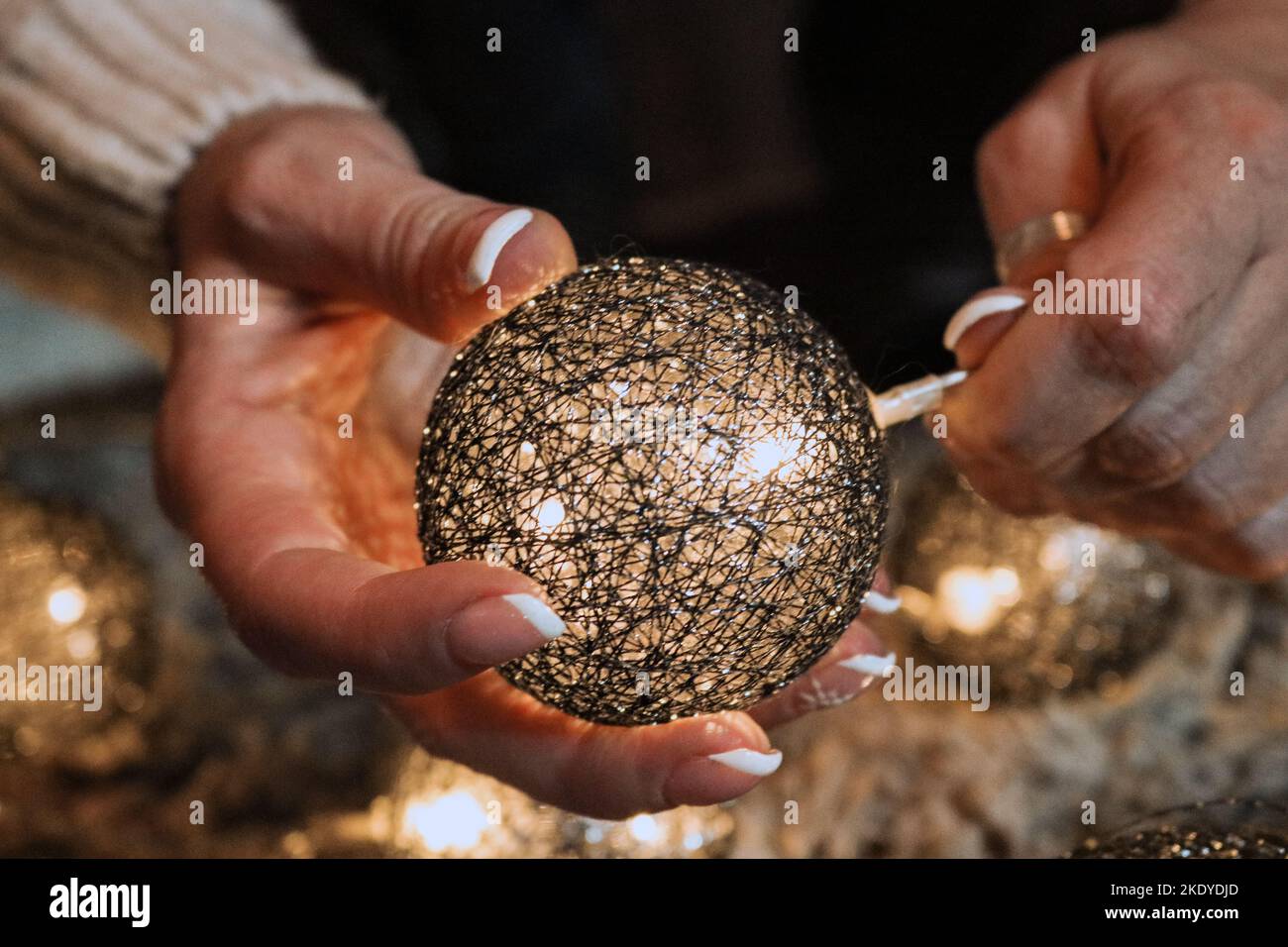 Woman's hands holding shiny ball Stock Photo - Alamy