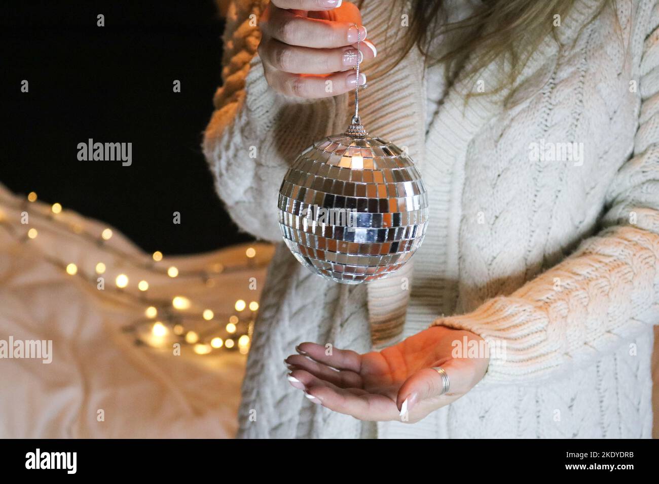 Woman's hands holding shiny ball Stock Photo - Alamy