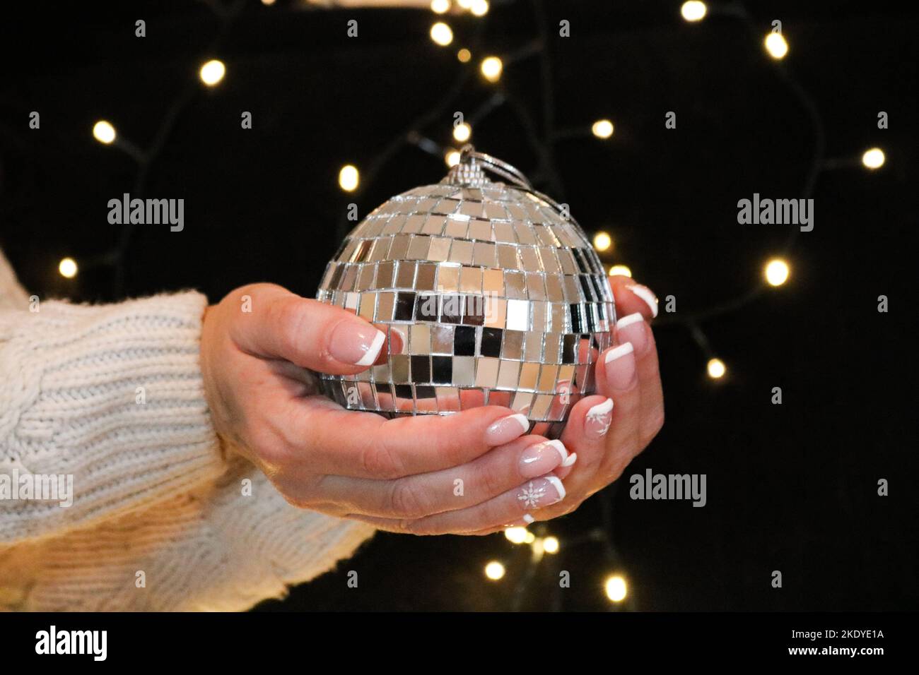 Woman's hands holding shiny ball Stock Photo - Alamy