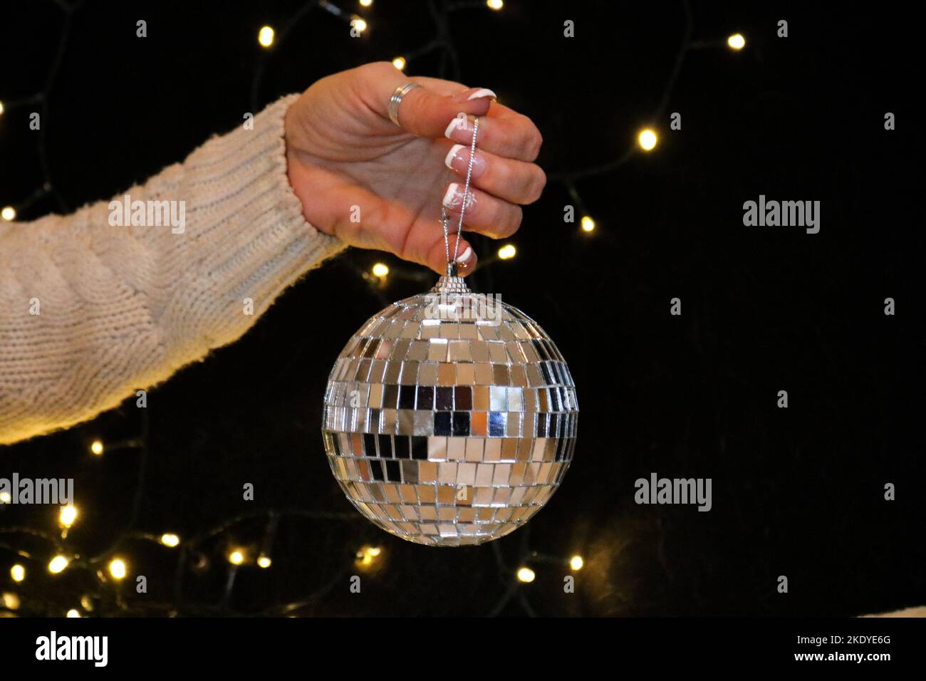 Woman's hands holding shiny ball Stock Photo - Alamy