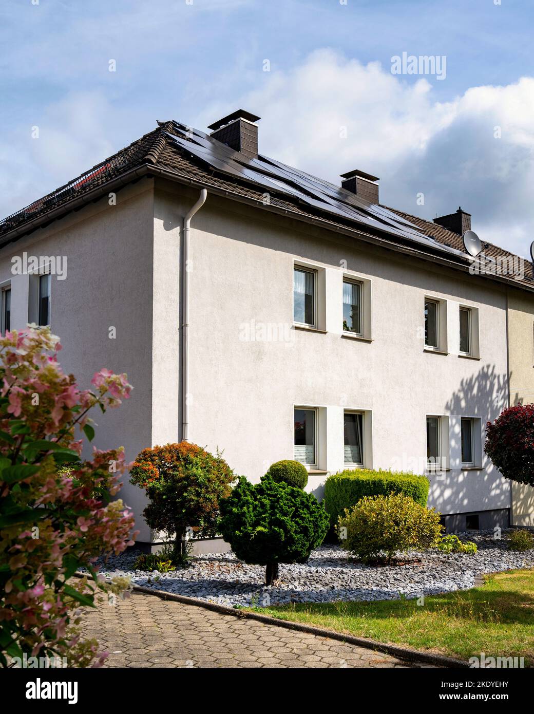 A vertical shot of a white mid-rise residential building with a ...