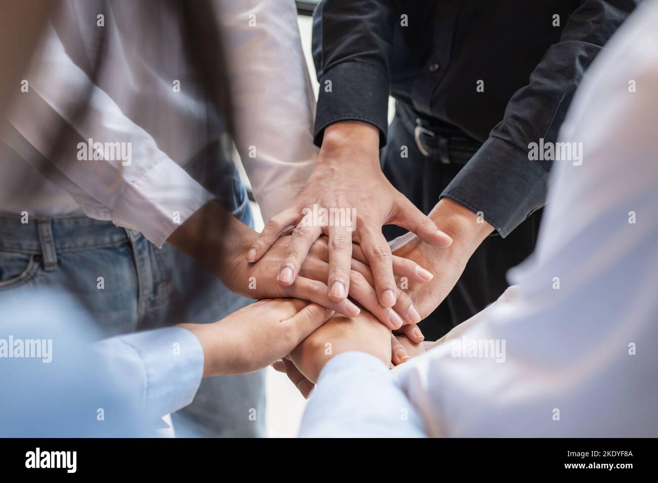 Group of business people putting their hands working together on wooden ...