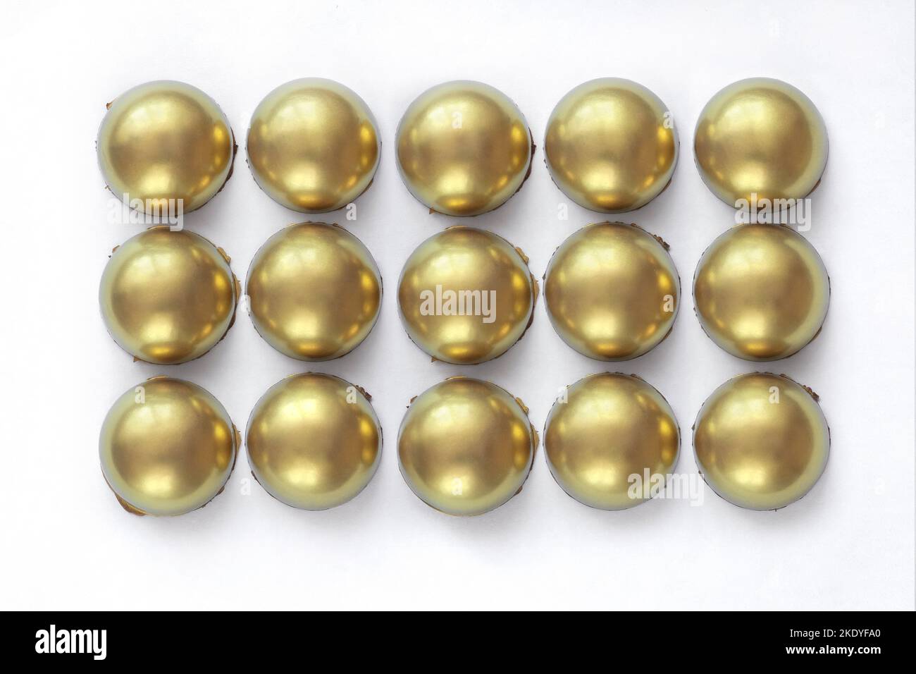 Chocolate half spheres painted of golden spray color. Decor for party ...