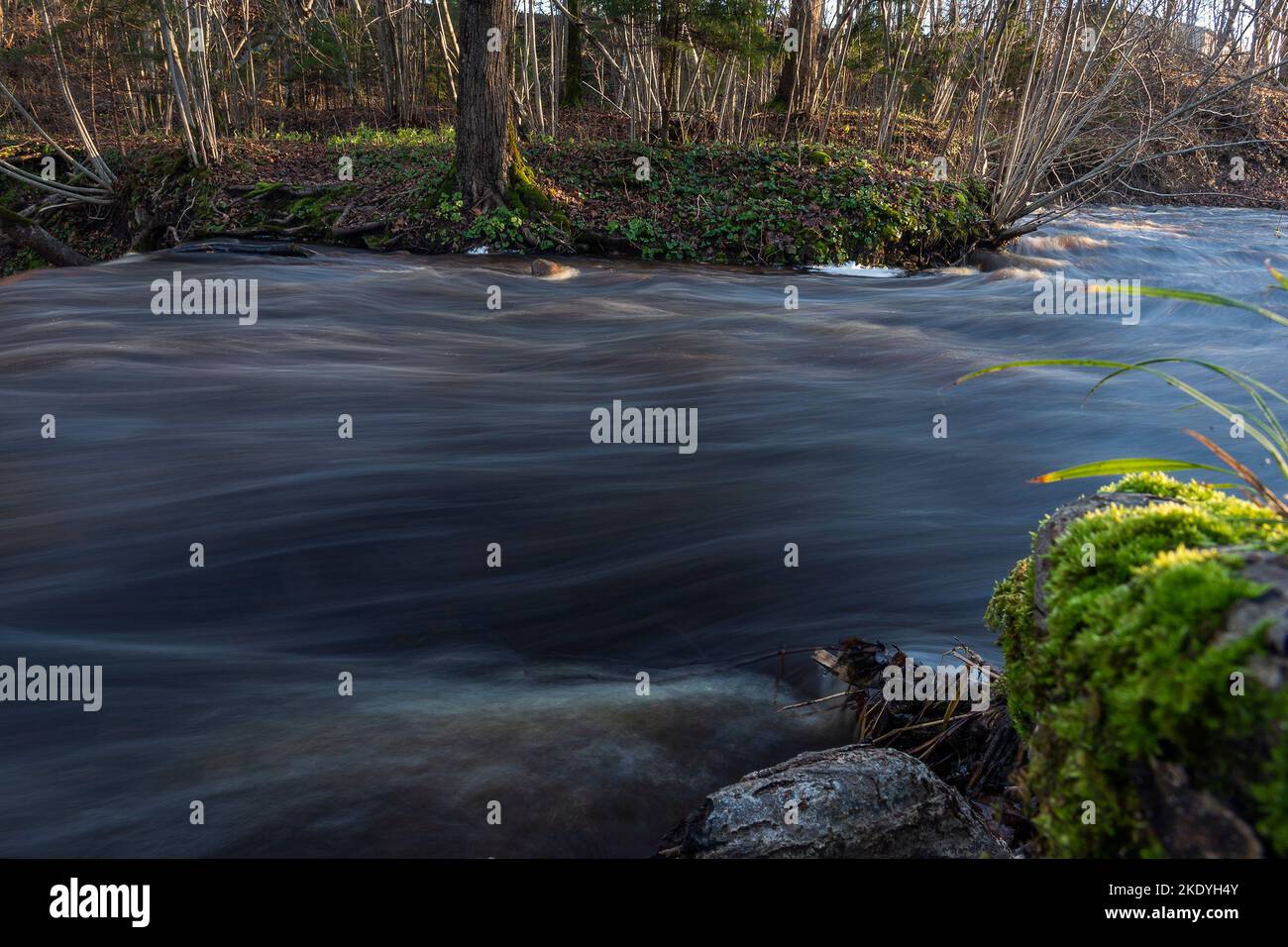 Big water in small river Stock Photo - Alamy