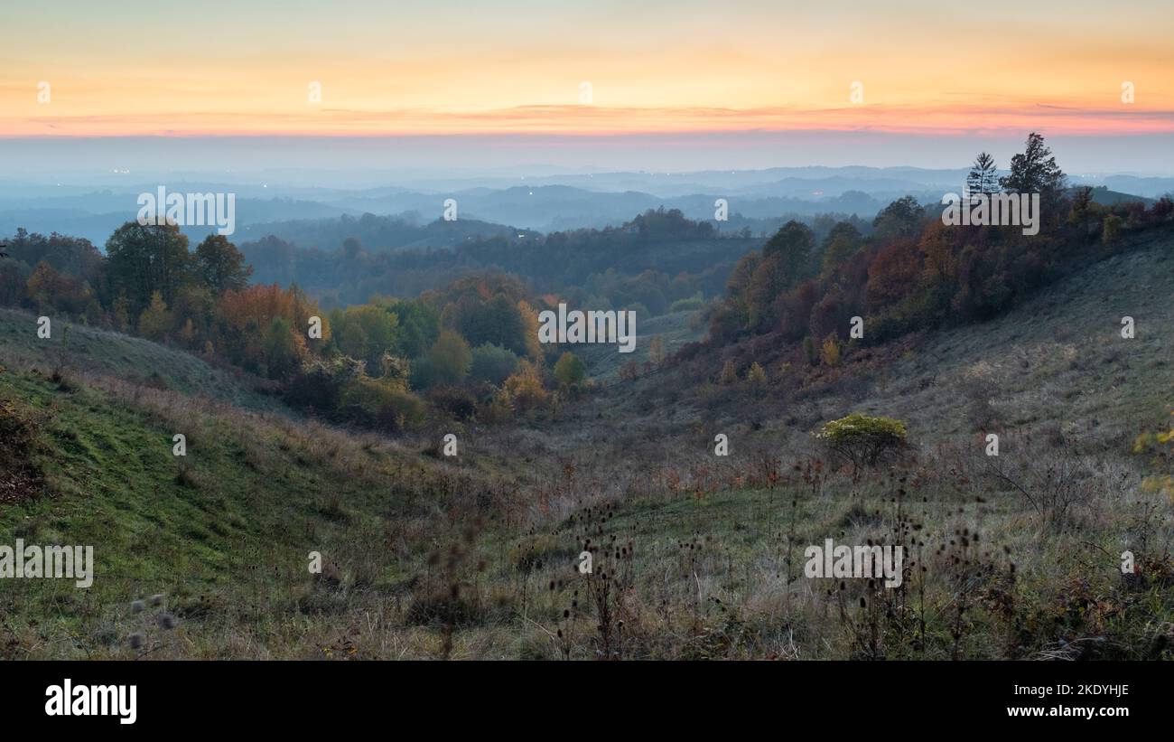 Rural landscape during dusk in autumn, hilly countryside with lush ...