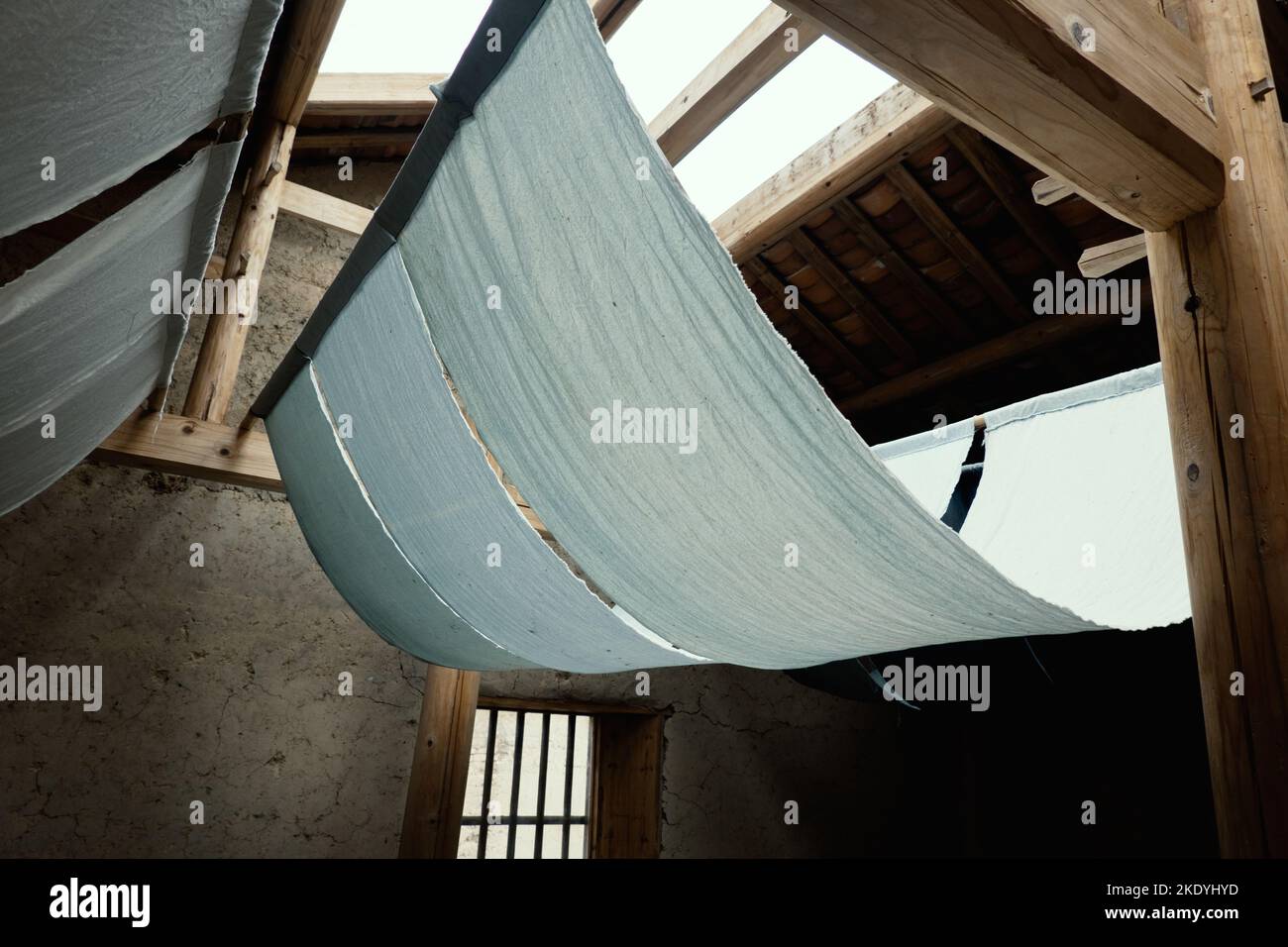 A vibrating cloth ceiling of an old house with stone walls and wooden ...