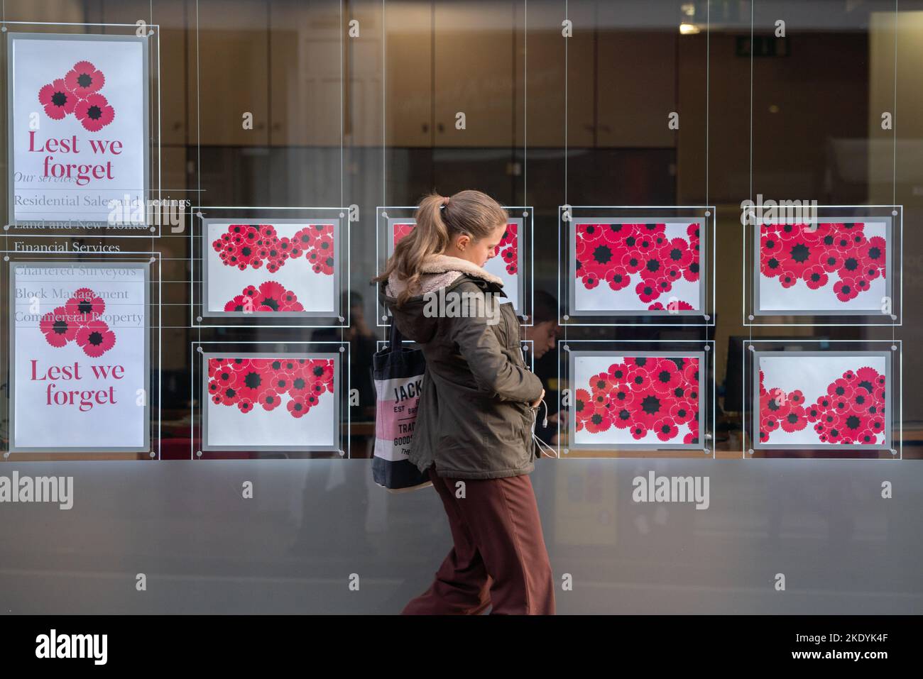 London UK. 9 November 2022. Pedestrians walk past a window of an estate ...