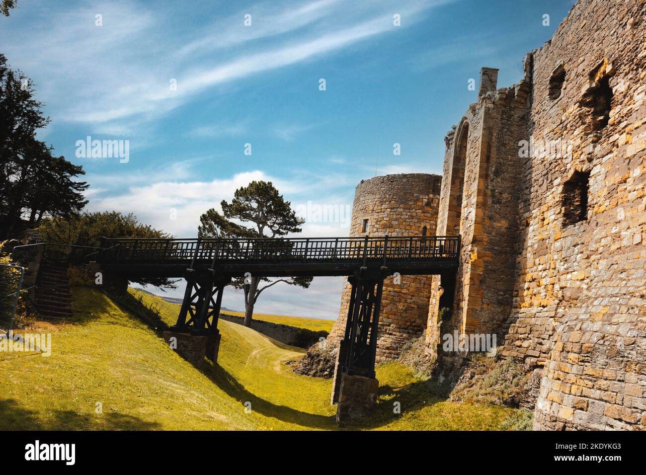 A beautiful view of a bridge and the walls of Dirleton Castle in North ...