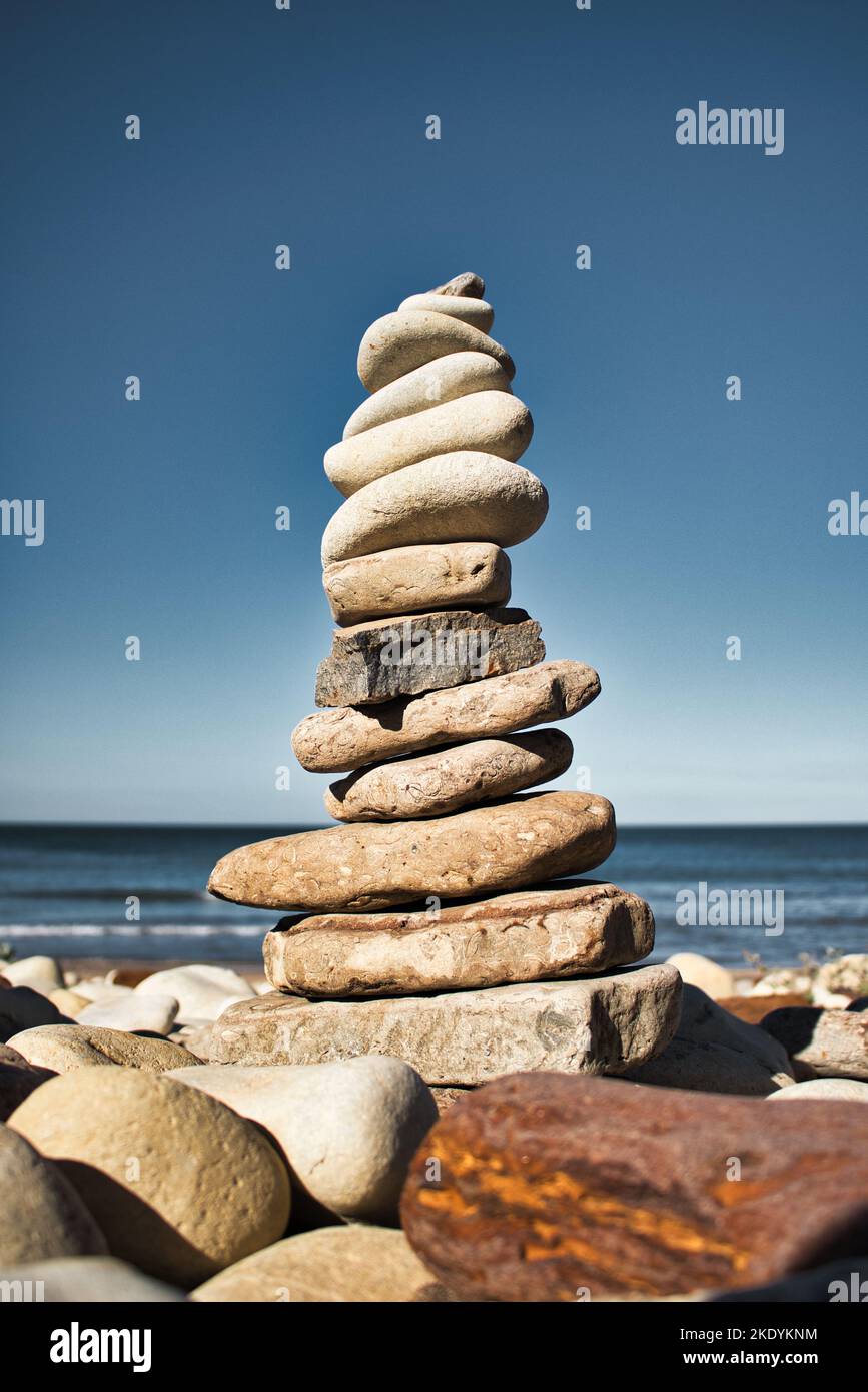 A vertical shot of a rock balancing in Isle of Wight, England Stock ...