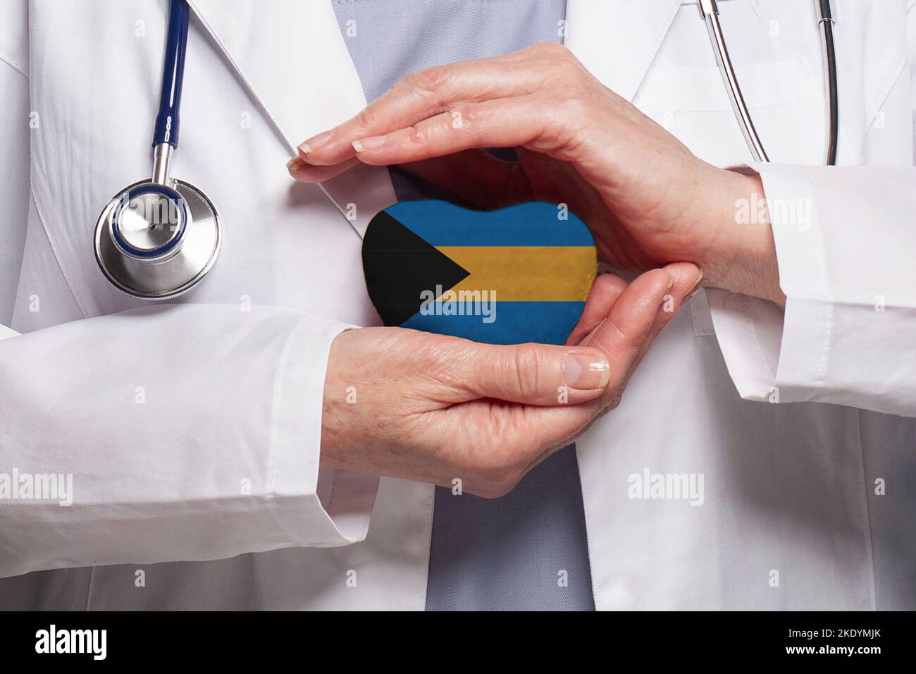 Bahamas doctor holding heart with flag of Bahamas background ...