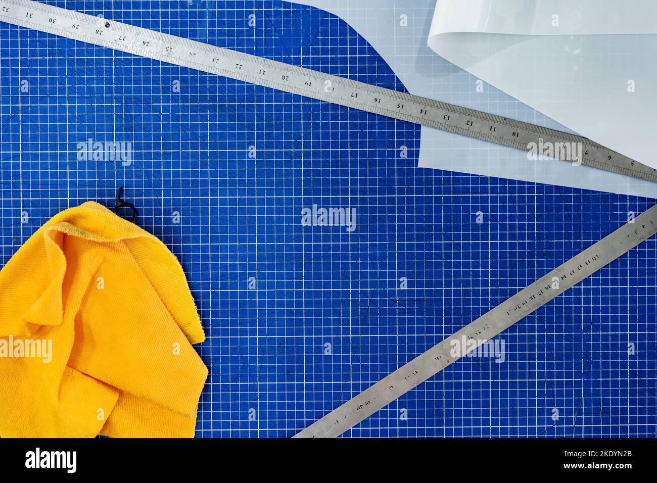 Desktop top view with blue cutting mat Stock Photo - Alamy