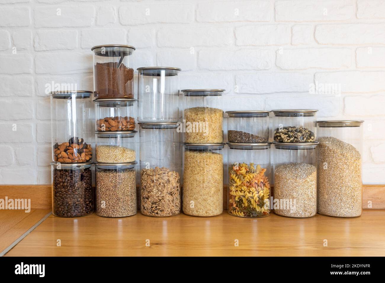 A stack of food storage containers filled with spices and grains Stock ...