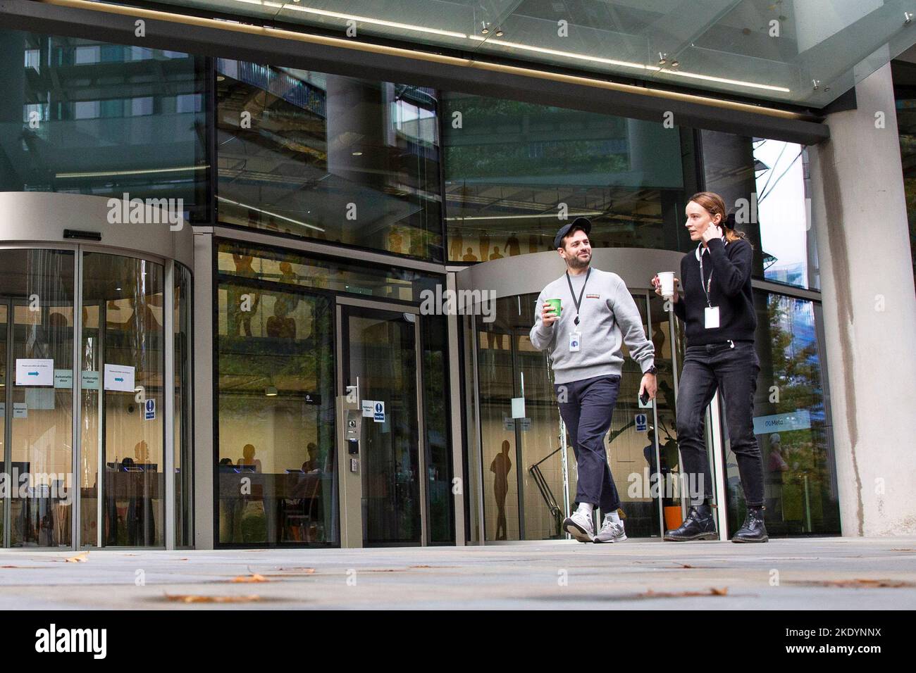A person walking outside the offices of Meta, the parent company of ...