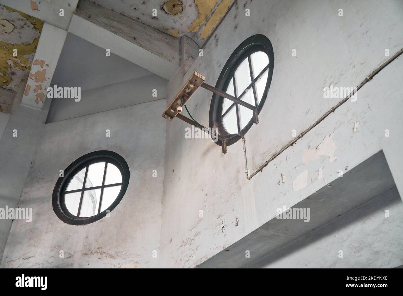 An interior view of an old watchtower with round windows in Indonesia ...