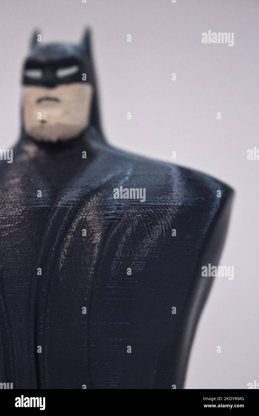 A closeup shot of a 3d printed batman toy figure isolated on an empty ...