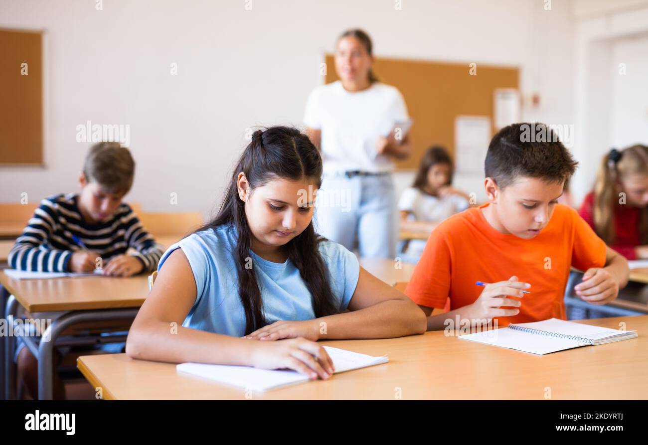 Boy and girl studying in classroom Stock Photo - Alamy