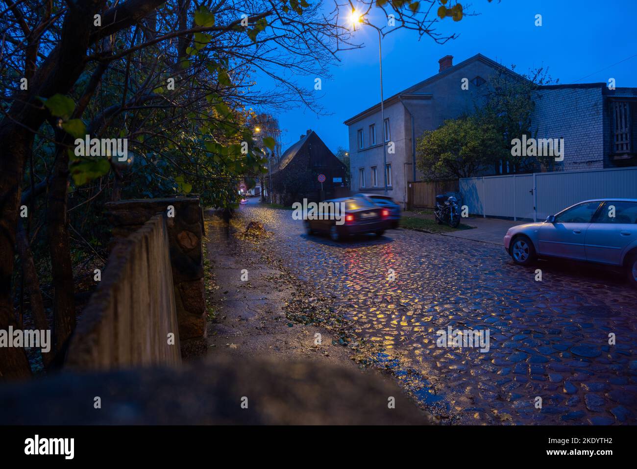 Liepaja city street in rainy autumn evening Stock Photo - Alamy