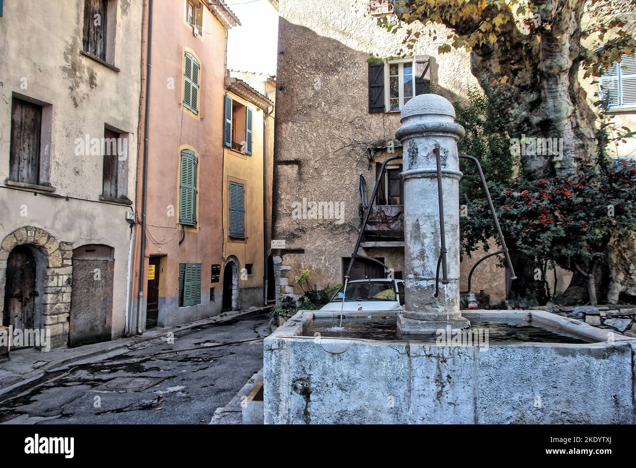 The Lorgue Fountain and buildings in the old city in France Stock Photo ...