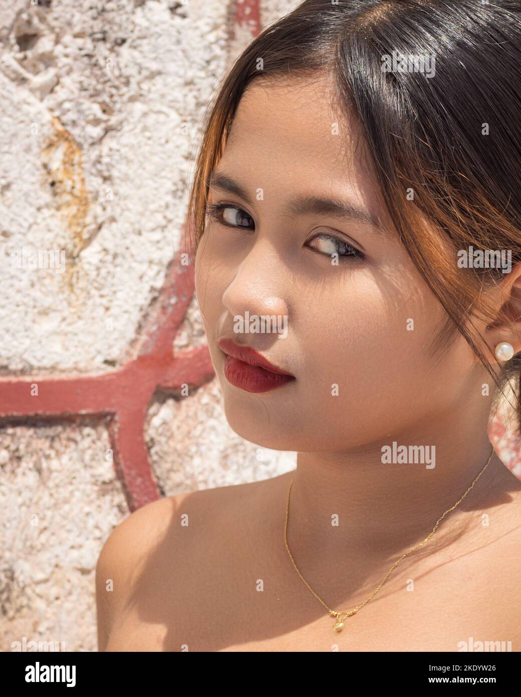Portrait Of Beautiful Filipino Girl Posing In Front Of Camera The Background Of An Old Wall On