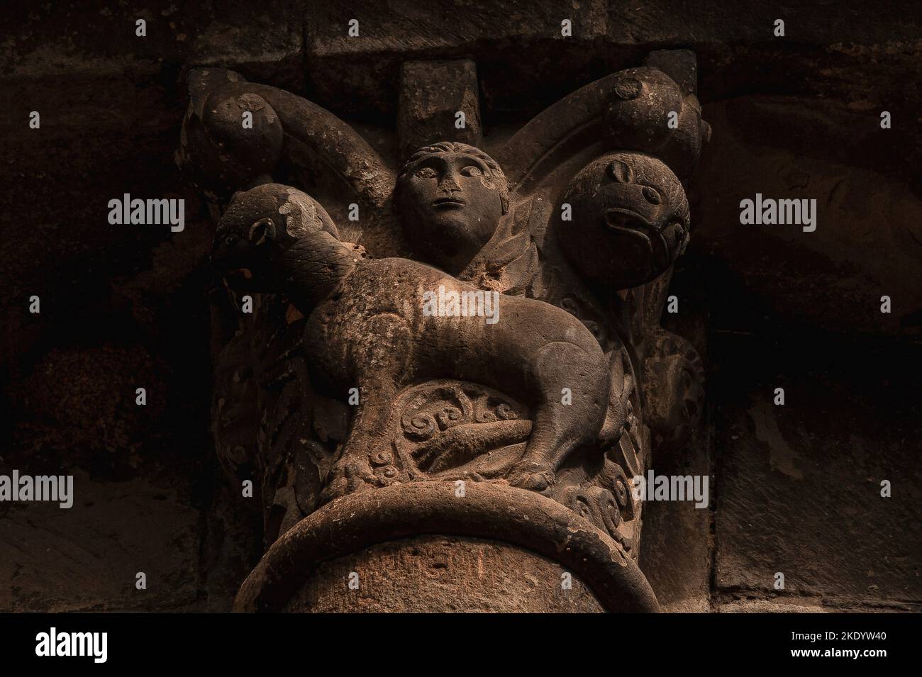 Round human faces above a standing lion with a replaced head ...