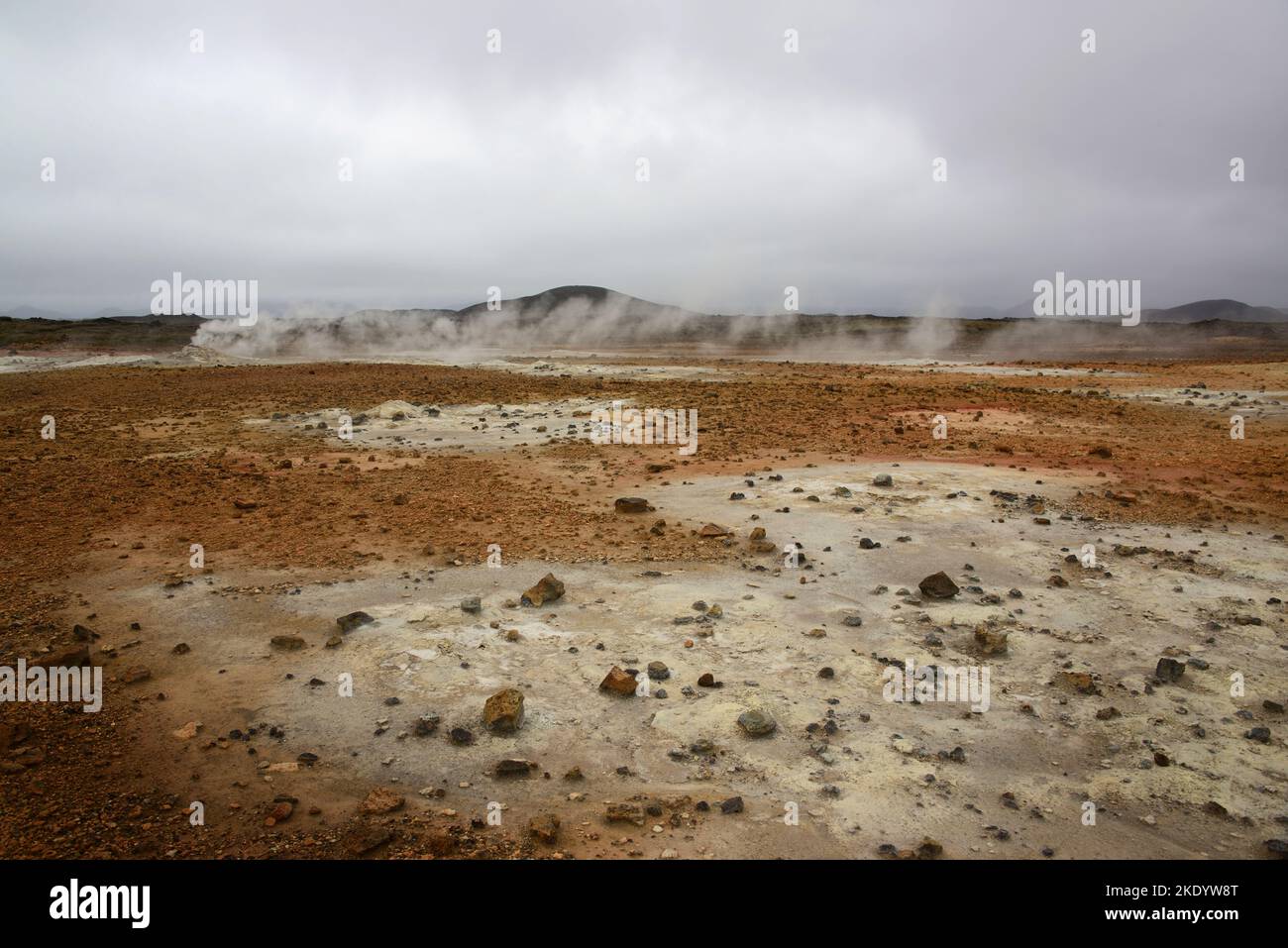 A scenic shot of rocks on a field with fog under a cloudy gloomy sky ...